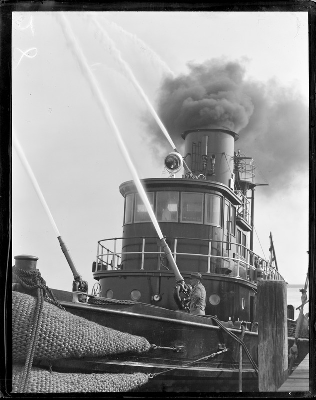 Fireboat Matthew J. Boyle firing water guns, tug - Digital Commonwealth