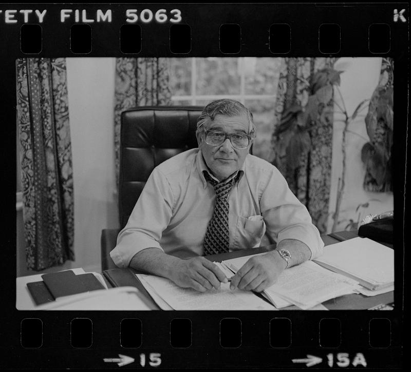 Peter Matthews at desk in office - Digital Commonwealth