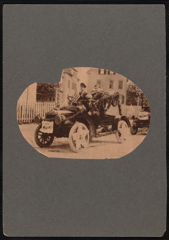 Car with sign The Maxwell decorated with garlands and American flag for ...