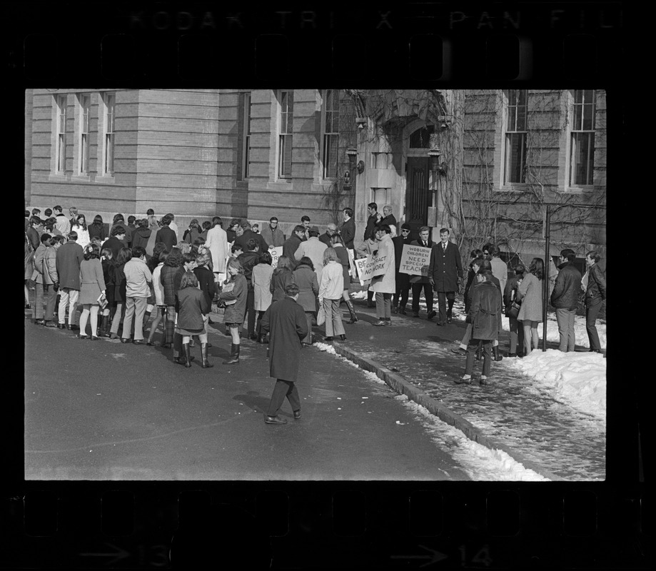 Students watch their teachers march the picket line outside of Woburn ...