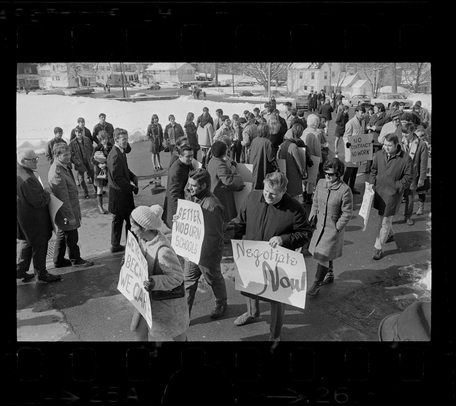Students watch their teachers march the picket line outside of Woburn ...