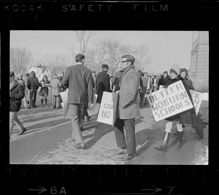 Students watch their teachers march the picket line outside of Woburn ...