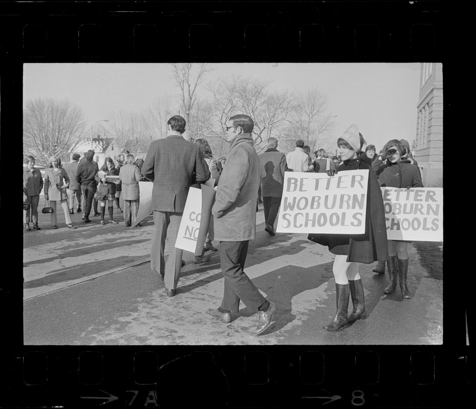 Students watch their teachers march the picket line outside of Woburn ...