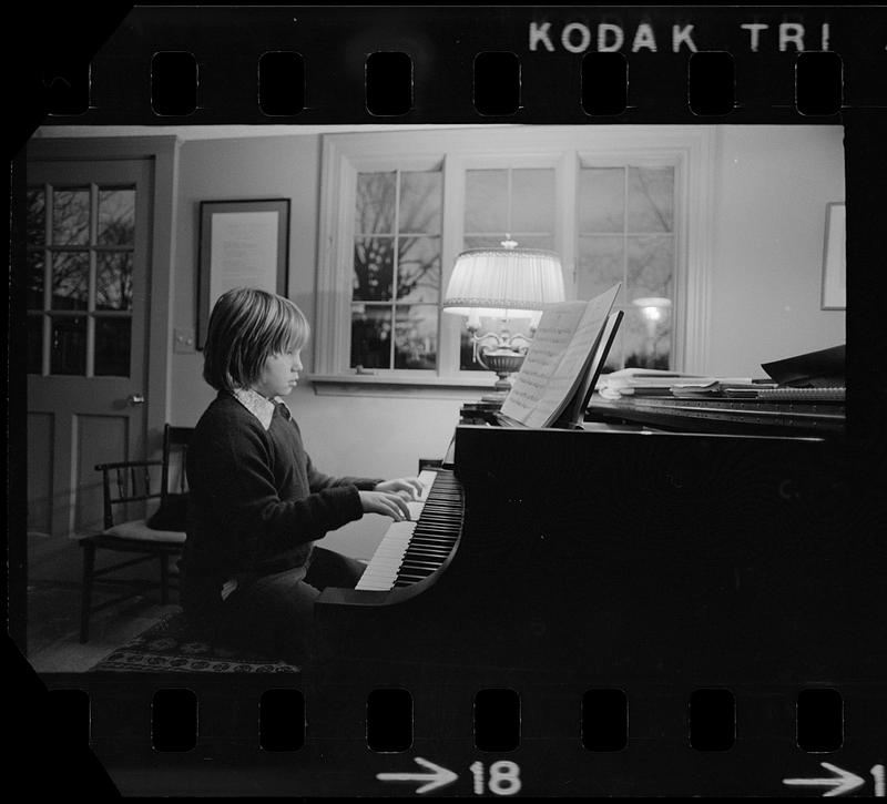 Bruce Irving's child playing the piano - Digital Commonwealth