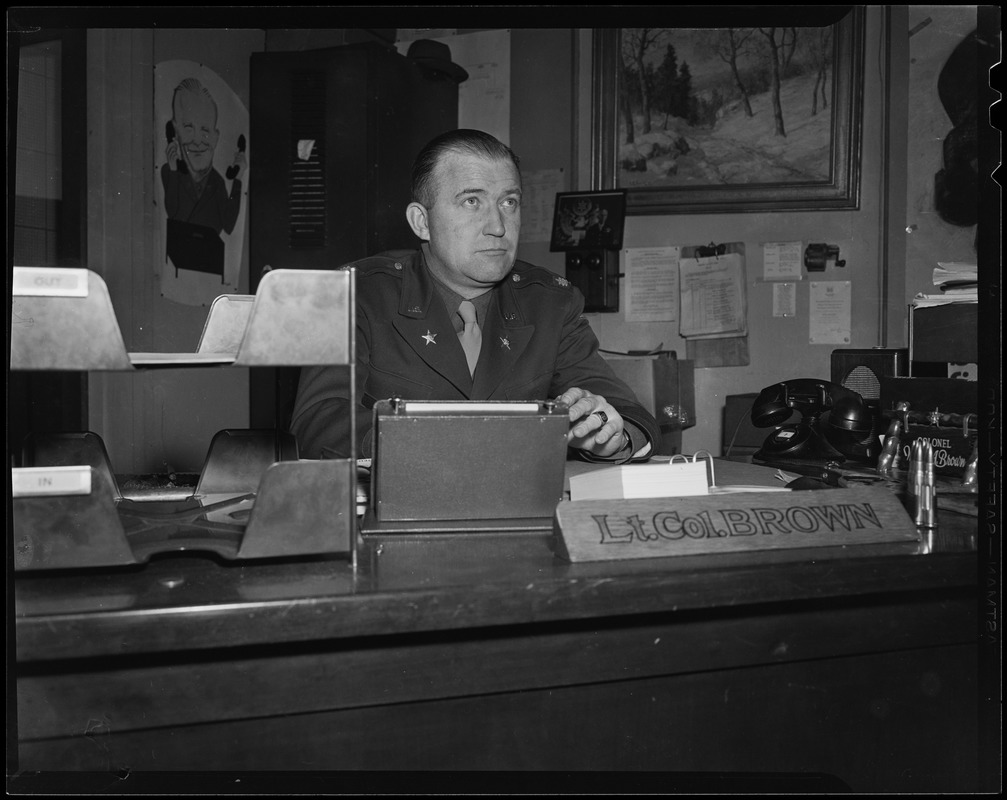 Lt. Col. Walter A. Brown sitting in military uniform at desk with ...