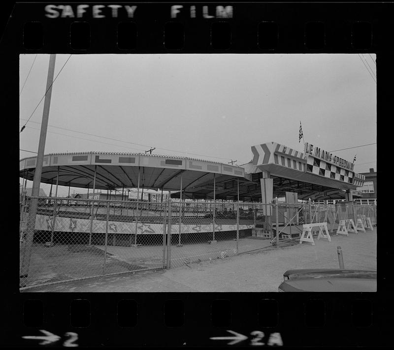Le Mans Speedway track behind chain-link fence - Digital Commonwealth