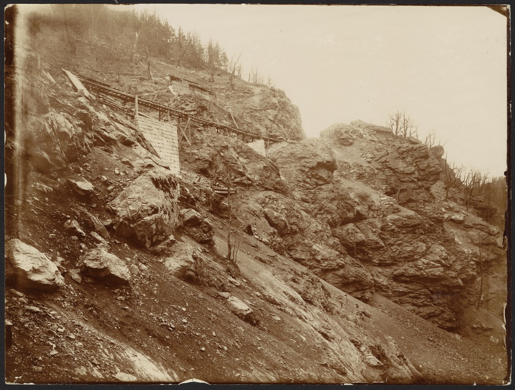 View of a rocky slope with wooden tracks/bridge - Digital Commonwealth