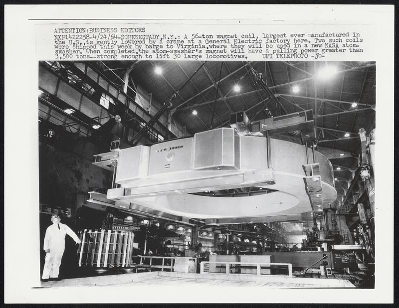 A 56-ton magnet coil, largest ever manufactured in the U.S., is gently ...