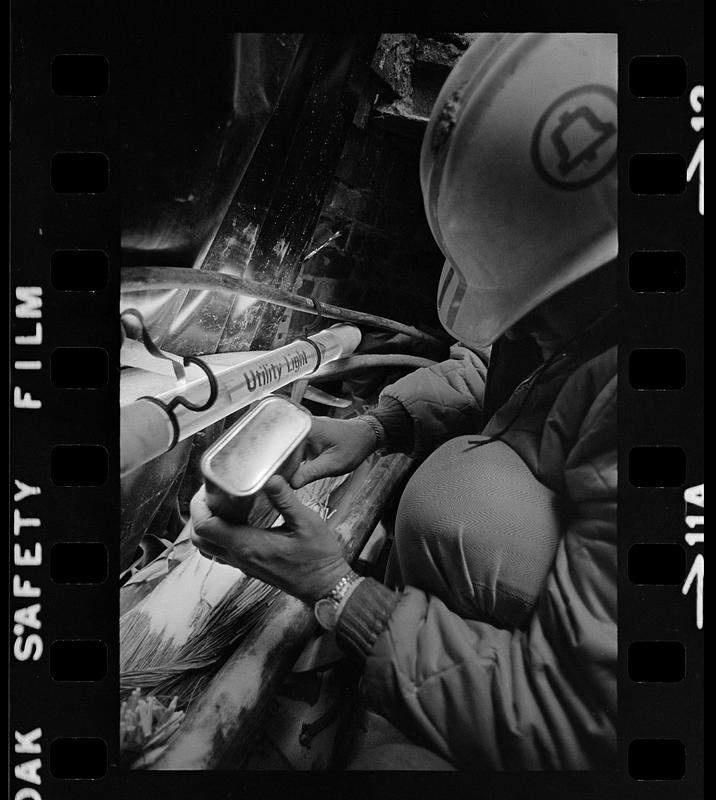 New England Bell technician works at underground cables, Boston ...