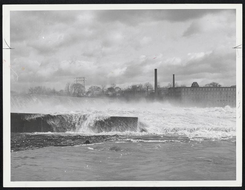 Water of the flood-swollen Connecticut River rushes over the Holyoke ...