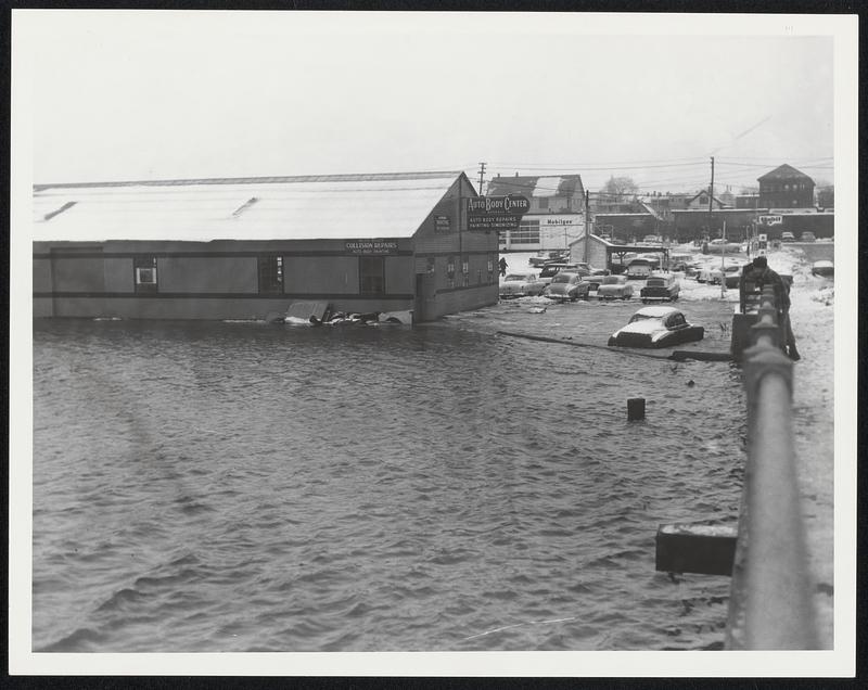 Boys looking over railing of Hall Whittacker Bridge at car + bldg ...