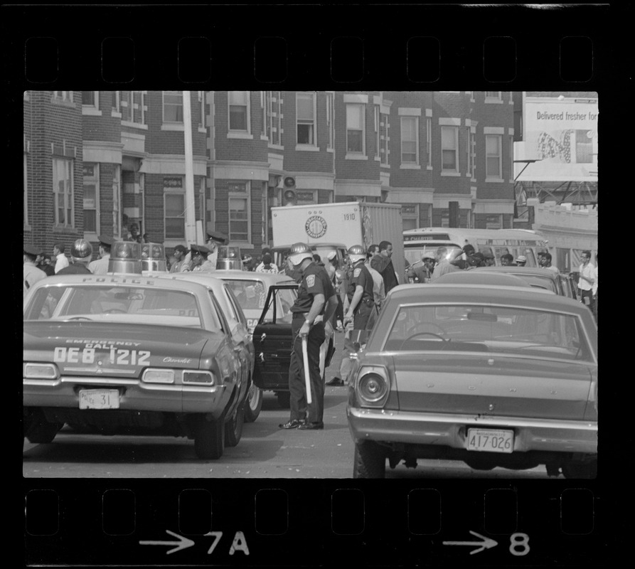 Riot police standing among cars on Washington Street near Jeremiah E ...