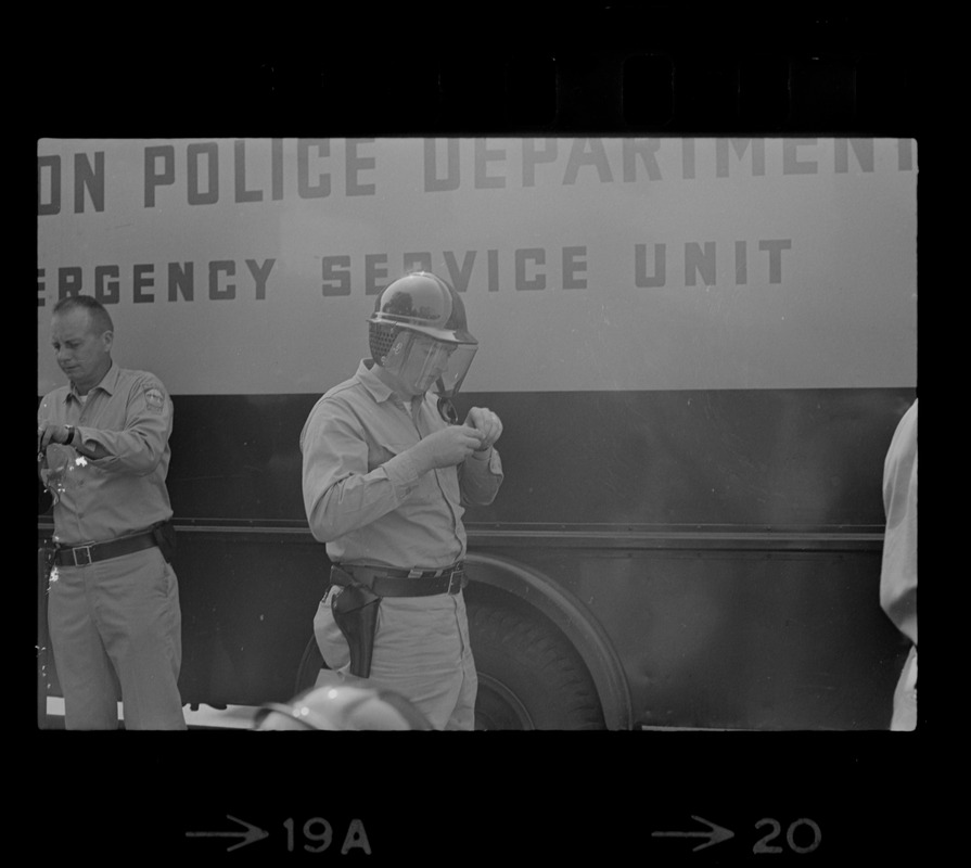 Policeman in riot gear standing in front of a Boston Police Emergency ...