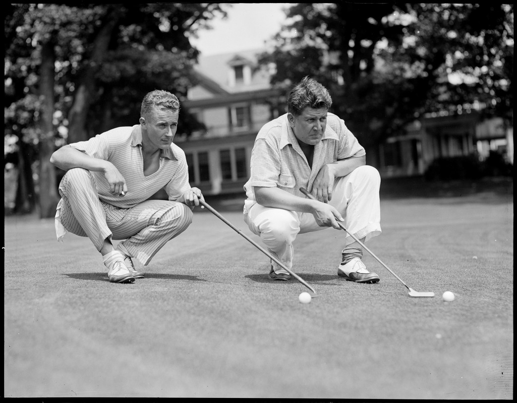 Two golfers line up shots on the green - Digital Commonwealth