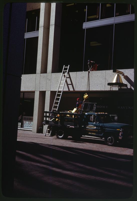 Two men moving things from one floor to another - Digital Commonwealth