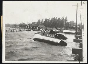 Storm Lashing Coast Spreads Damage. The wreckage strewn waterfront at ...