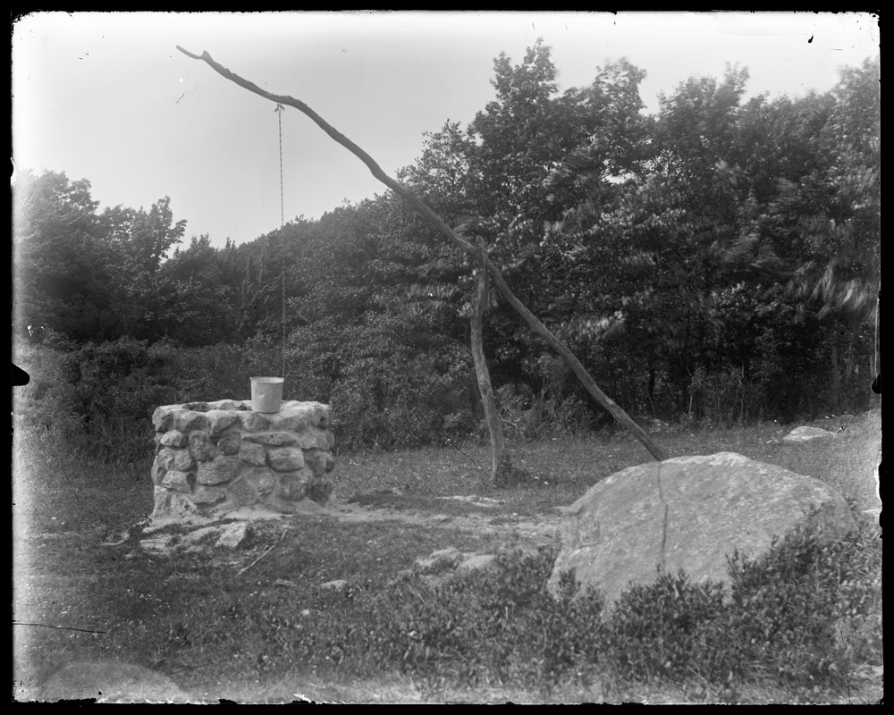 Well with sweep and large rock - Digital Commonwealth