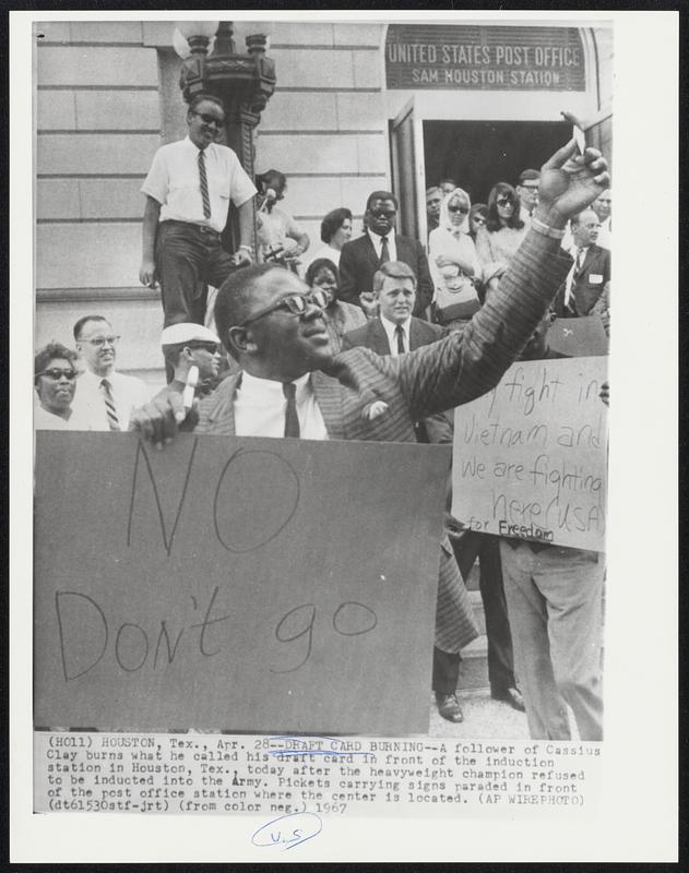 Draft Card Burning-- A follower of Cassius Clay burns what he called ...