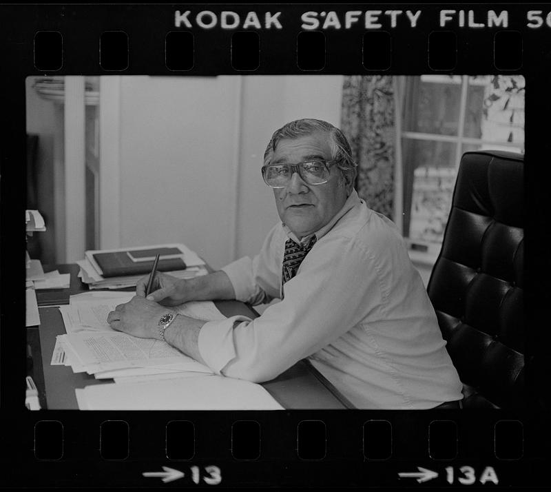 Peter Matthews at desk in office - Digital Commonwealth