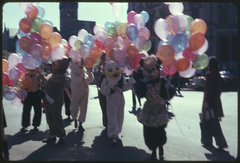 People holding balloons, some wearing costumes, Old South Church in background, Boston Columbus ...