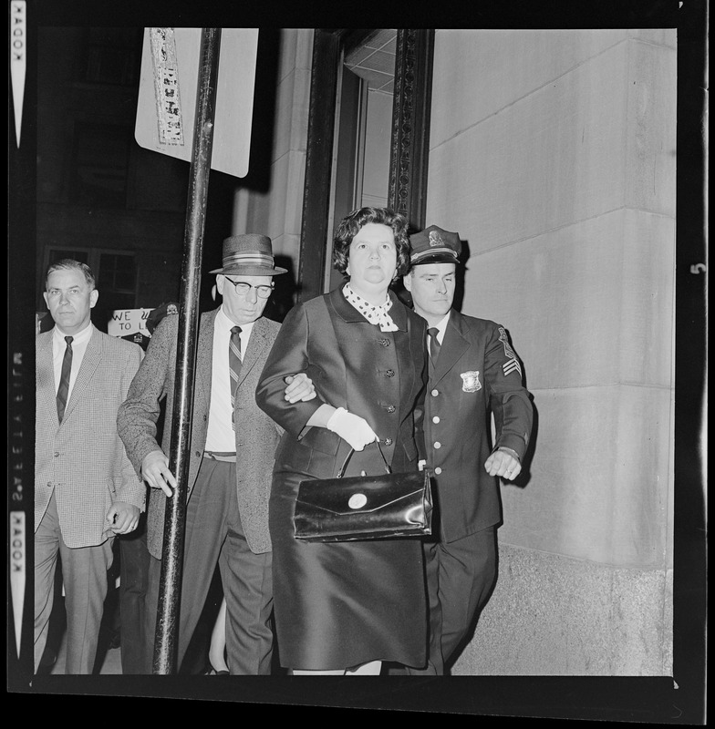 Louise Day Hicks leaving Boston School Committee meeting escorted by ...