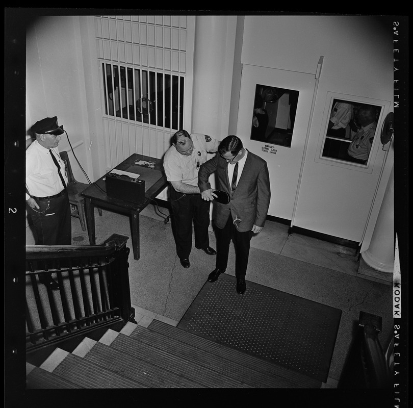 Prison guard using hand-held metal detector at Charles Street Jail ...