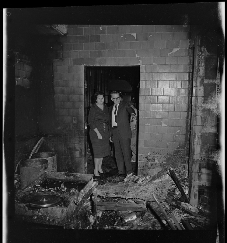 Mrs. Louise Day Hicks and Timilty School Principal view charred debris ...