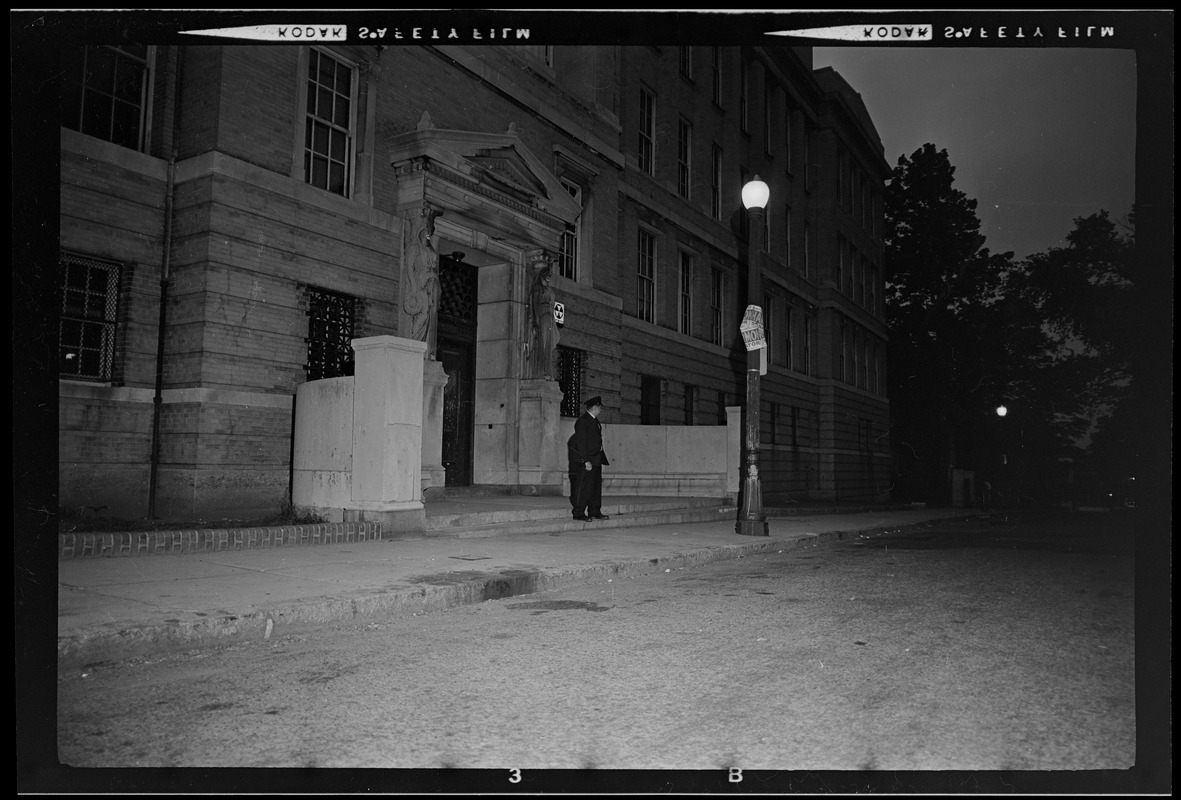 Police officer outside entrance to building - Digital Commonwealth