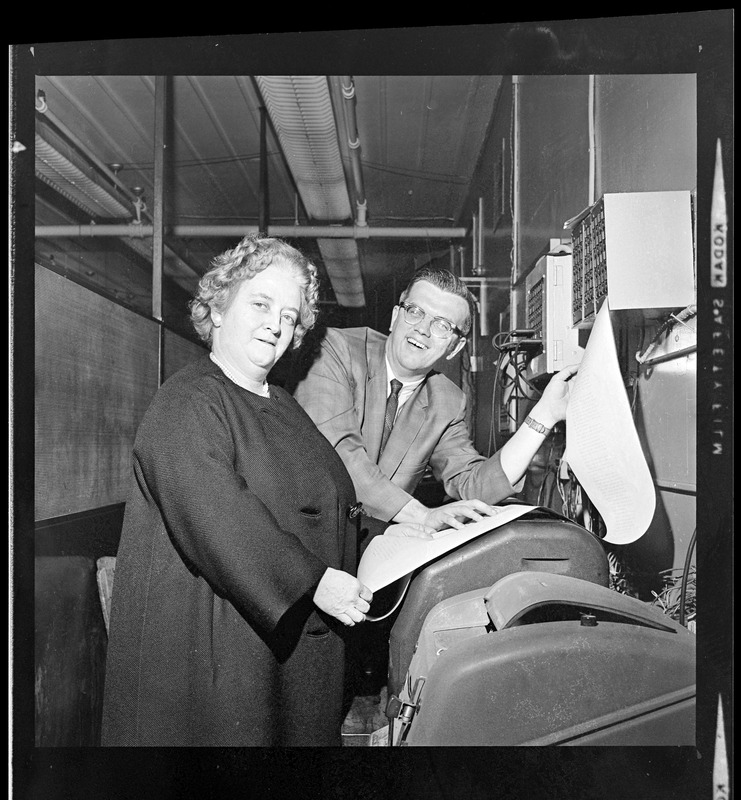 Unidentified woman and man at teletype machine - Digital Commonwealth