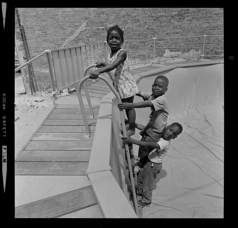 Three children at empty above-ground pool - Digital Commonwealth