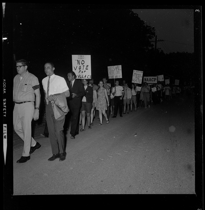 Protestors against George Wallace marching with signs along road ...