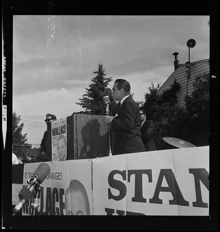 George Wallace speaking from podium at outdoor political rally ...