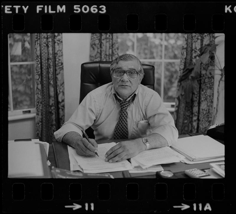 Peter Matthews at desk in office - Digital Commonwealth