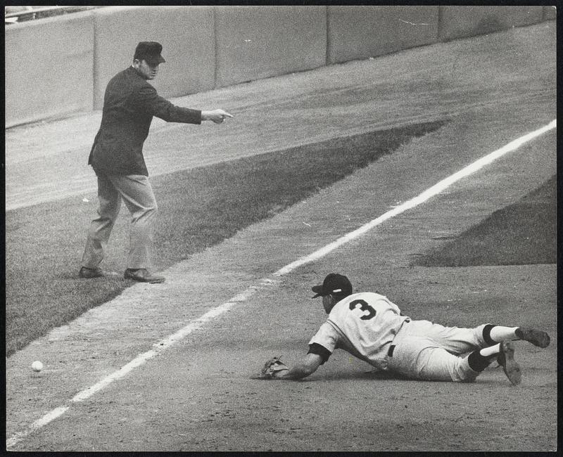 Umpire signals fair ball after a hit down the 3rd base line gets past ...