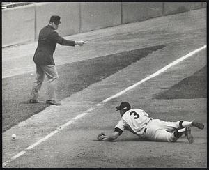 Umpire signals fair ball after a hit down the 3rd base line gets past ...