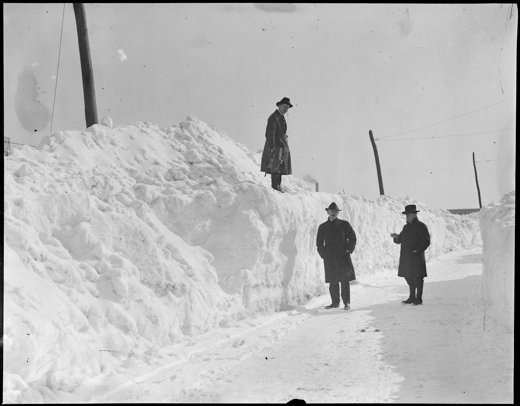 Big blizzard makes people look like specks, as they climb might drifts ...