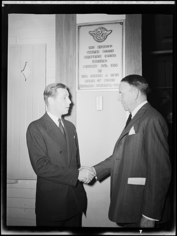Boston Mayor Maurice Tobin and H. D. Hodgkinson shake hands at opening ...