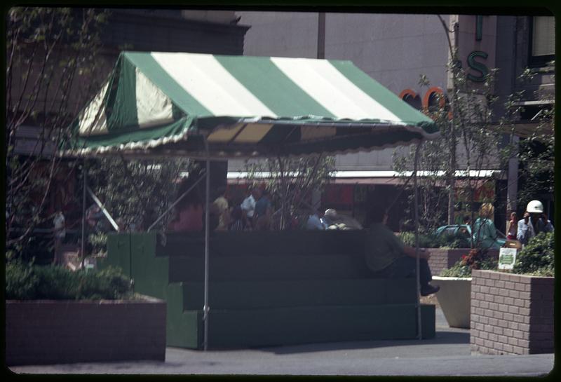 Seating covered by green and white canopy - Digital Commonwealth