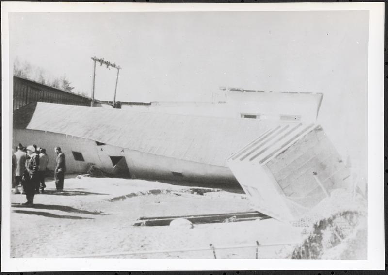 Exterior building collapsed, men in foreground - Digital Commonwealth
