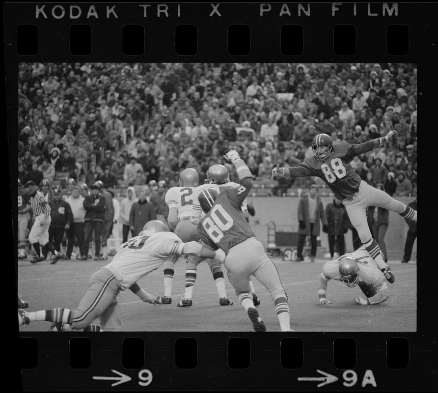 Boston College football player tackling Holy Cross player (80) in a ...