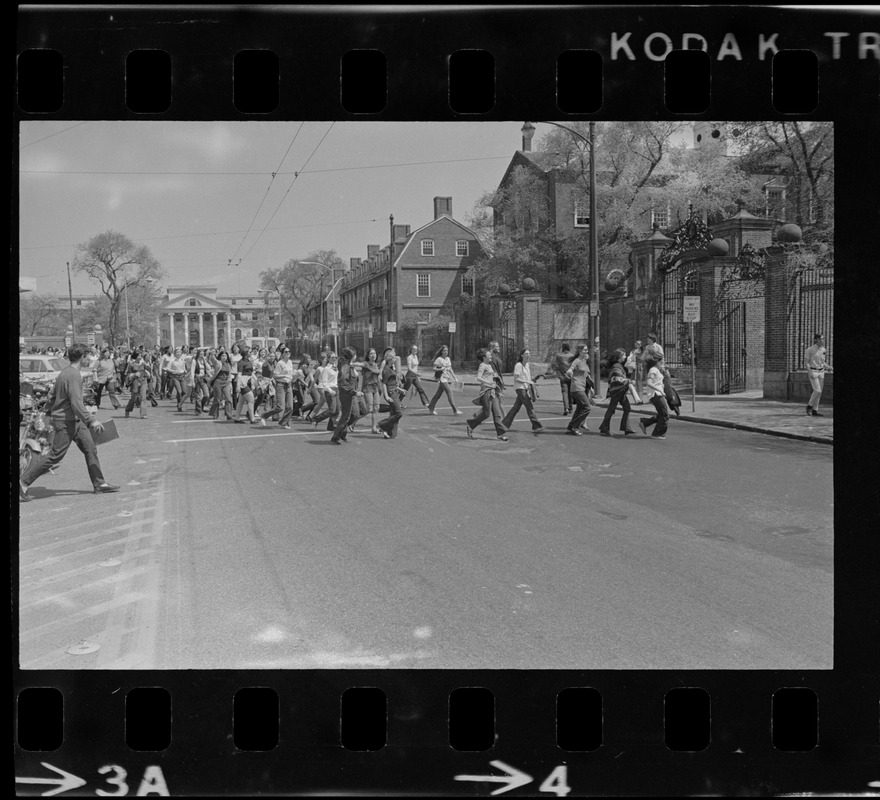 Students march across JFK Street in Cambridge toward Harvard Yard to ...