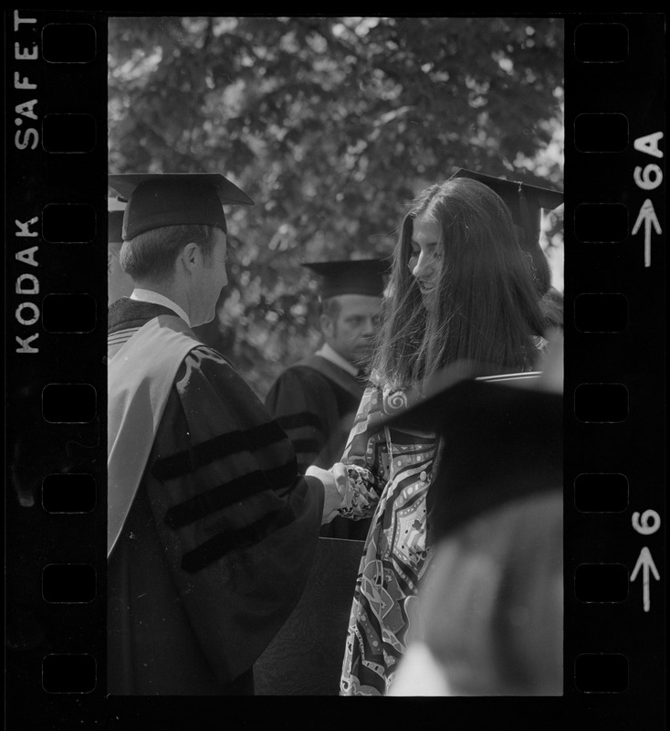 A Tufts University graduate receives her diploma without cap and gown ...