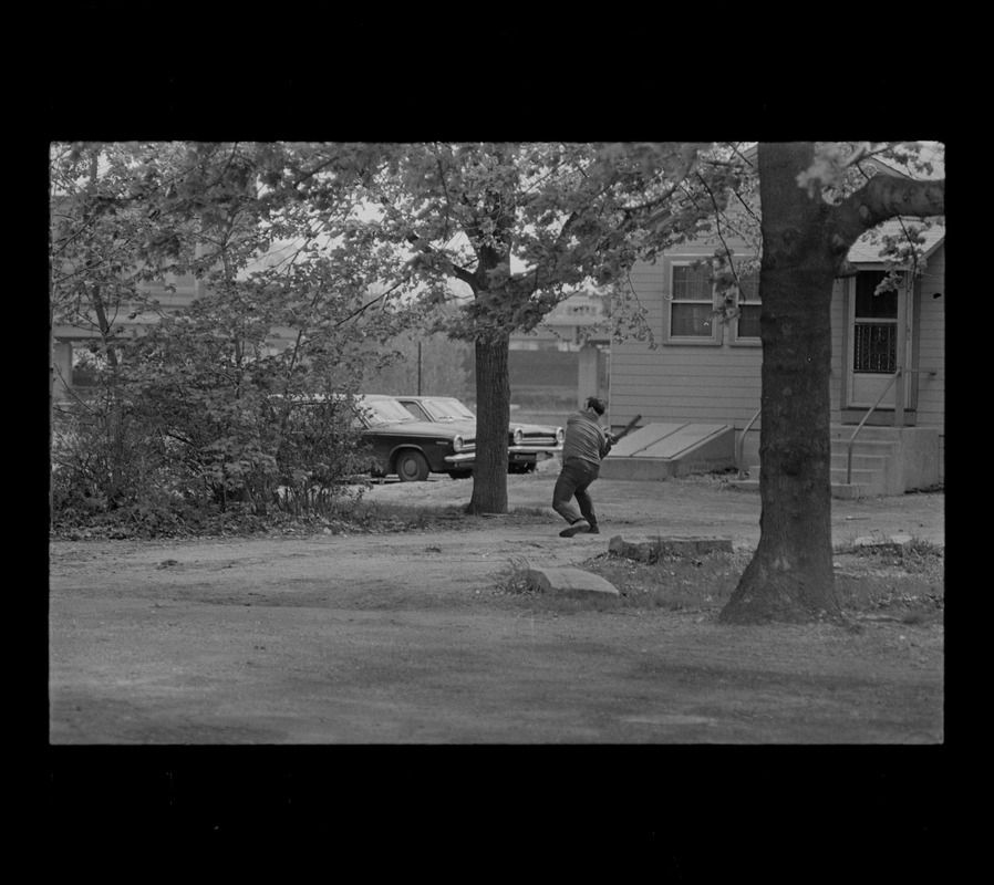 A man seen throwing an object - Digital Commonwealth