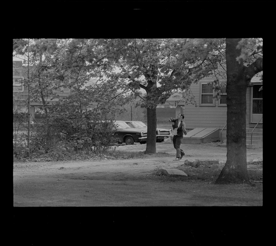 A man seen throwing an object - Digital Commonwealth