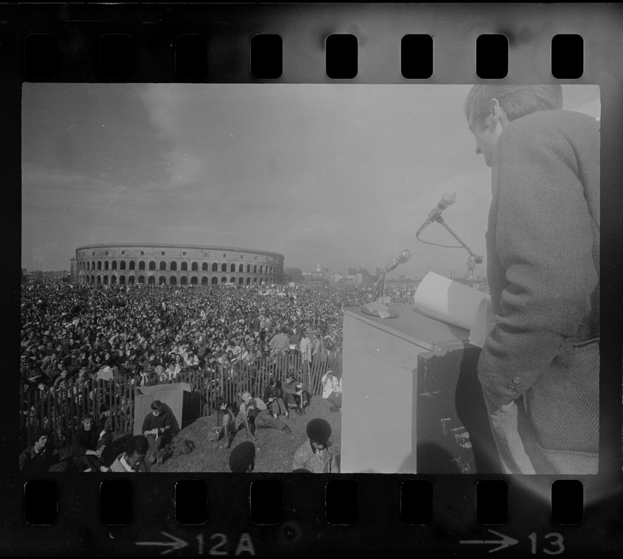 A man speaking to the crowd at a student rally at Soldiers Field ...