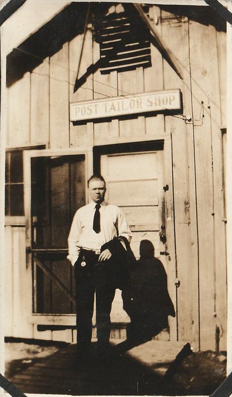 Unidentified man in front of the Post Tailor Shop, Marine base Quantico ...