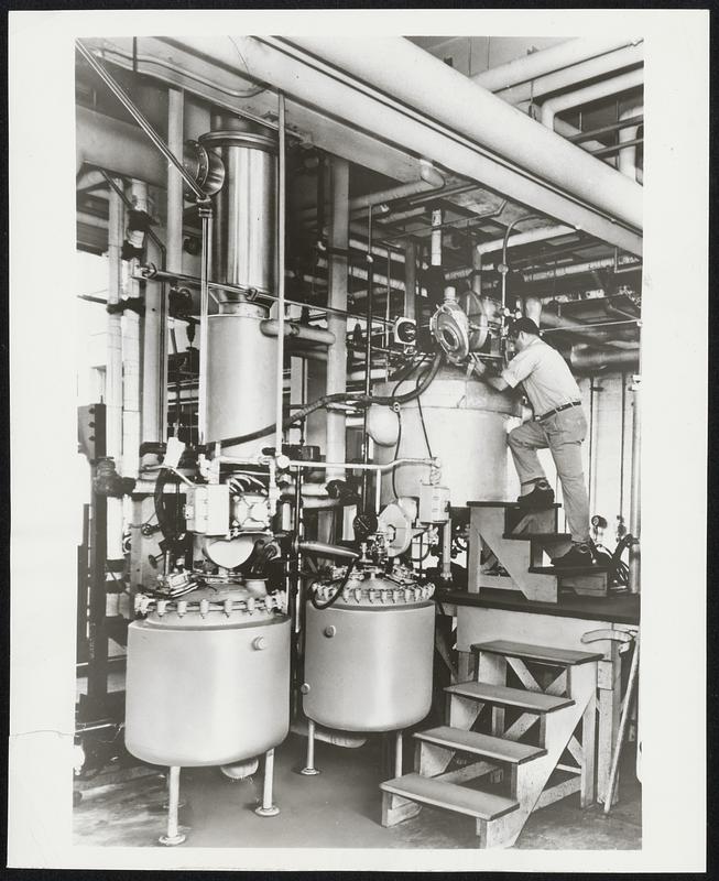 The Rodney Hunt Turba-Film Evaporator (vertical column at center left ...