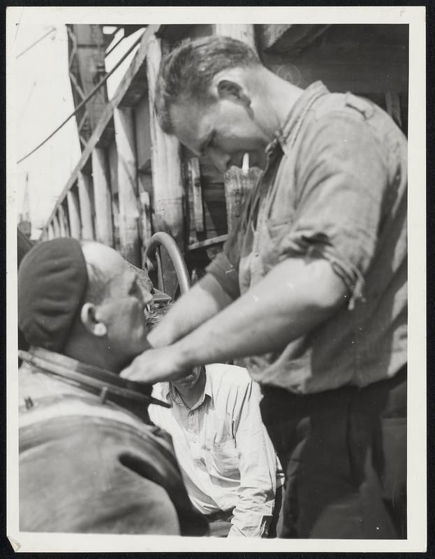 This valet has a fuzzy job in dressing the diver. Left, Bill Dunn and ...