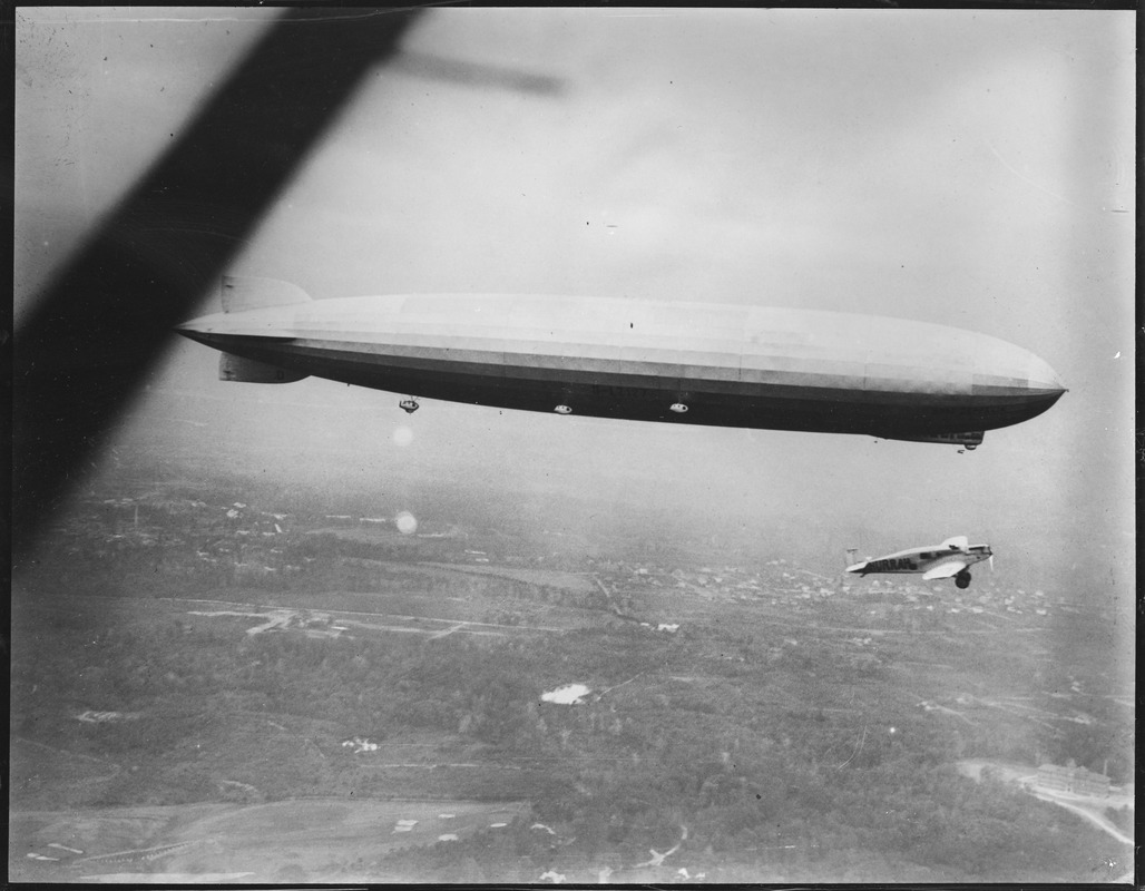 Dirigible and small single engine airplane - Digital Commonwealth