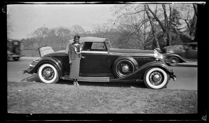 Constance Miller stands in front of a car - Digital Commonwealth
